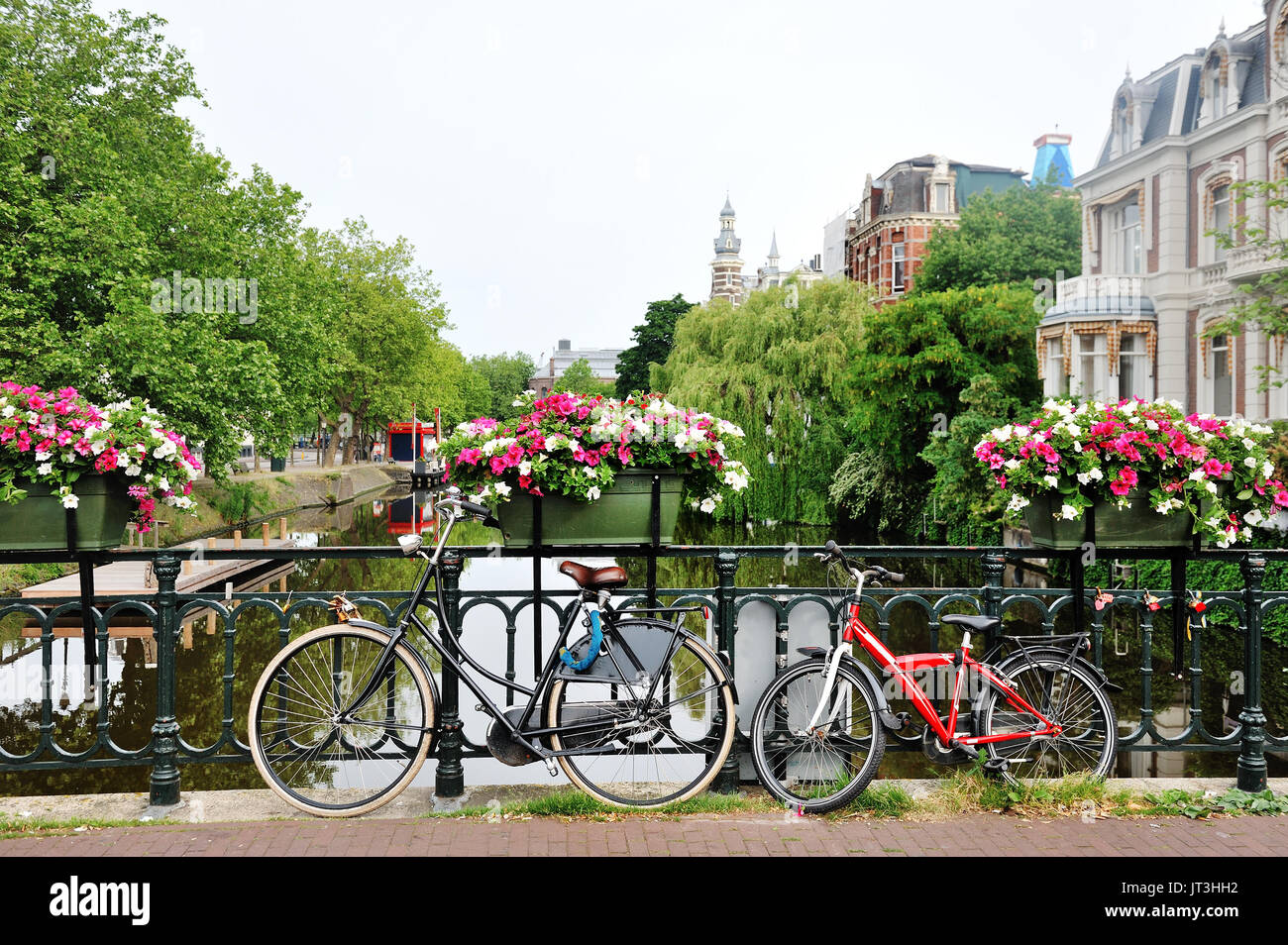 Amsterdam, Holland, Europe - bicycles and flowers over a bridge Stock ...