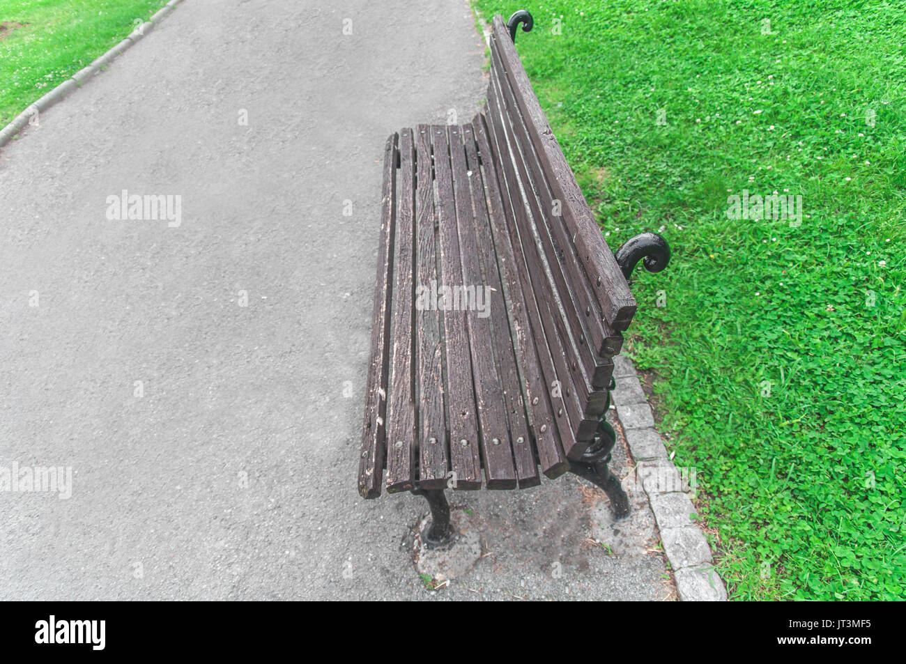 Old rusty bench in the park in the city center Stock Photo - Alamy