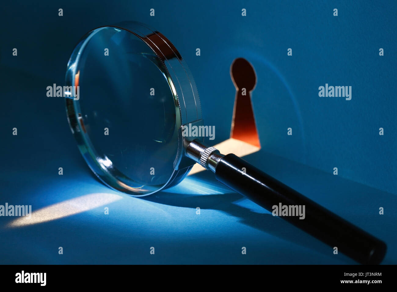 Spying concept. Magnifying glass near keyhole with beam of light Stock ...