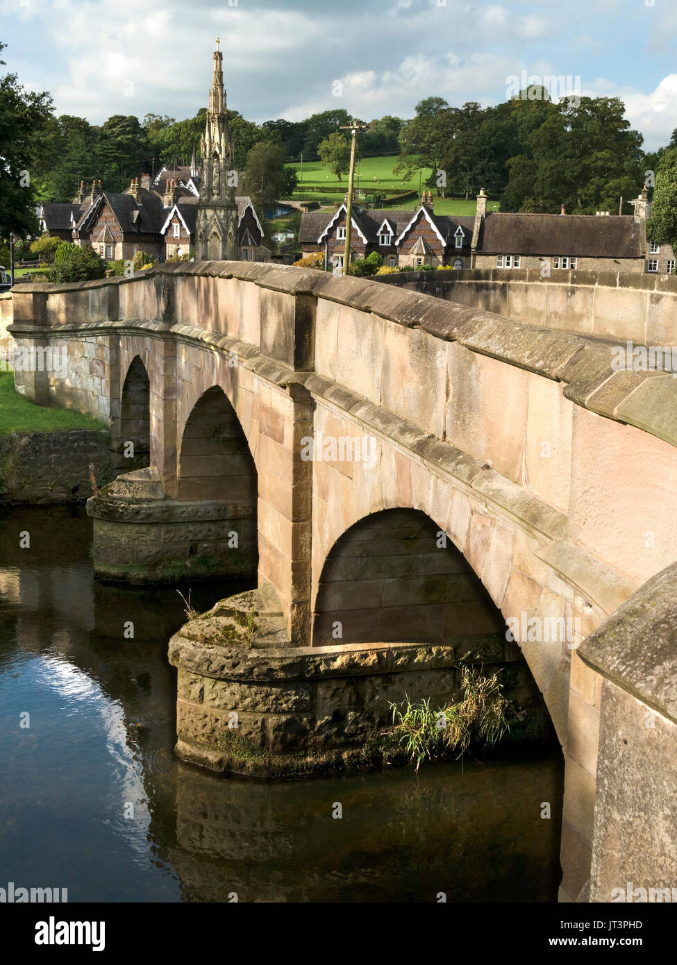 Stone arch bridge over River Manifold with village of Ilam beyond ...