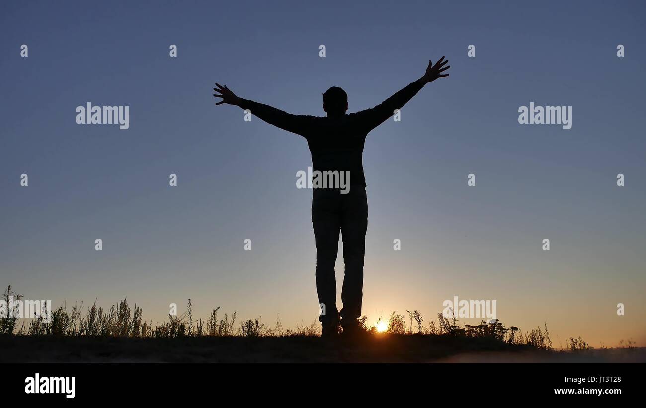The man silhouette spread his hands to the sides. Travel man freedom ...