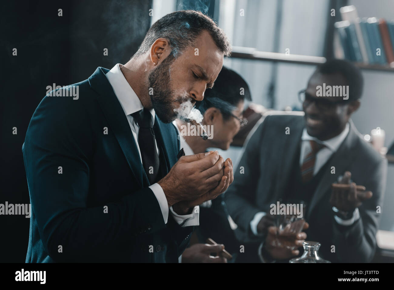 businessman smoking cigar with multicultural business team spending ...