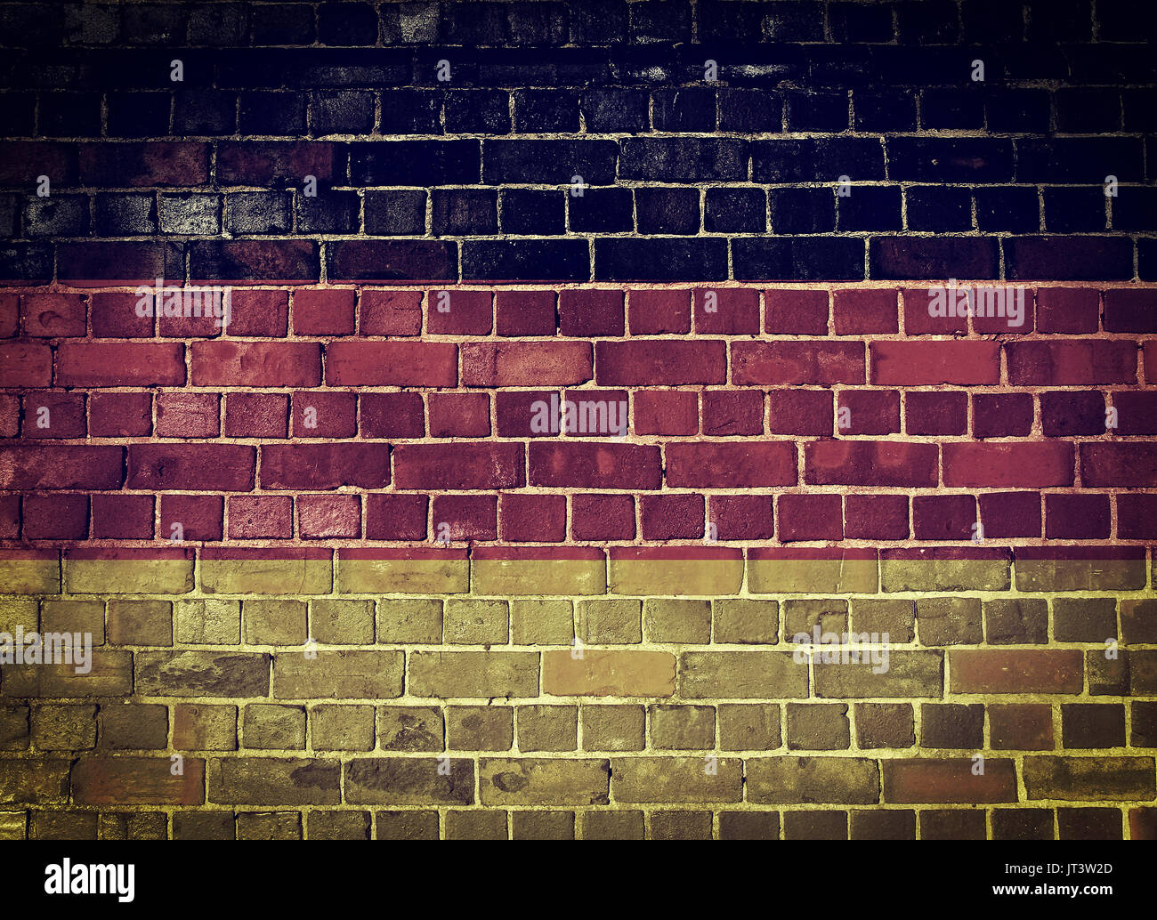 Faded German flag on an old brick wall background with a dark vignette ...