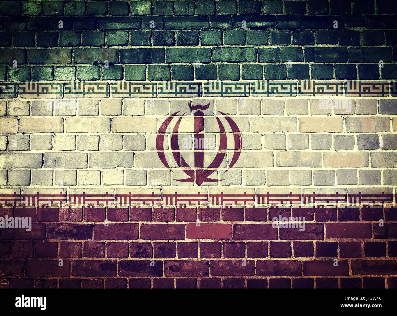 Faded Iranian flag on an old brick wall background with a dark vignette ...