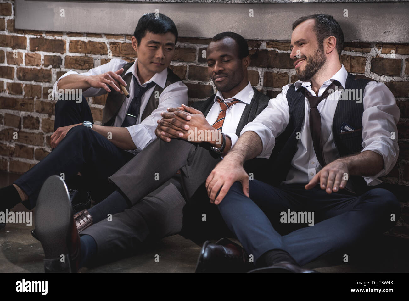 group of smiling stylish businessmen resting together after work Stock ...