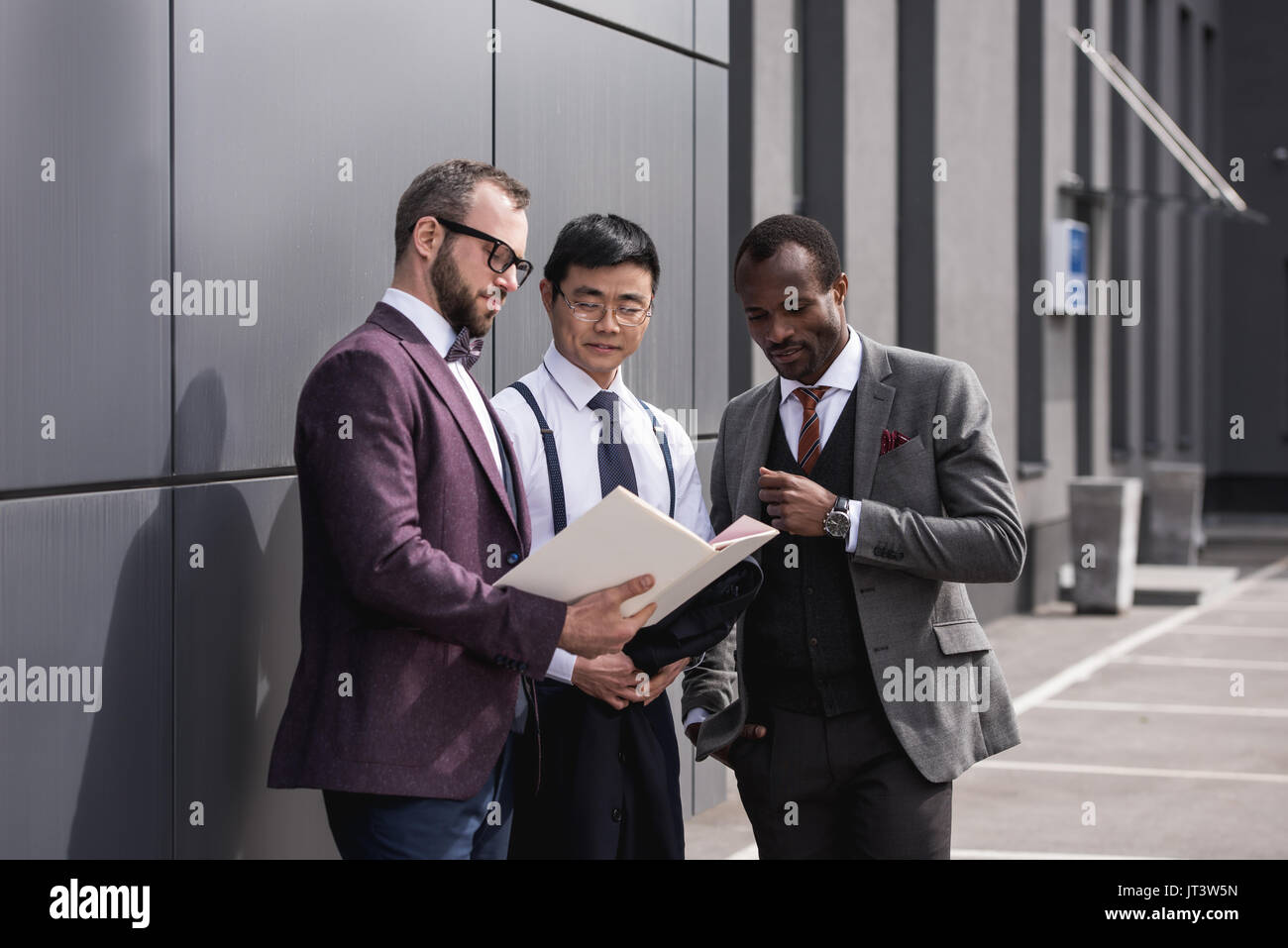 multicultural business team discussing work together near modern office ...