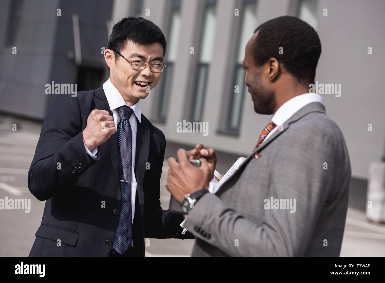 Men celebrating in suits hi-res stock photography and images - Alamy