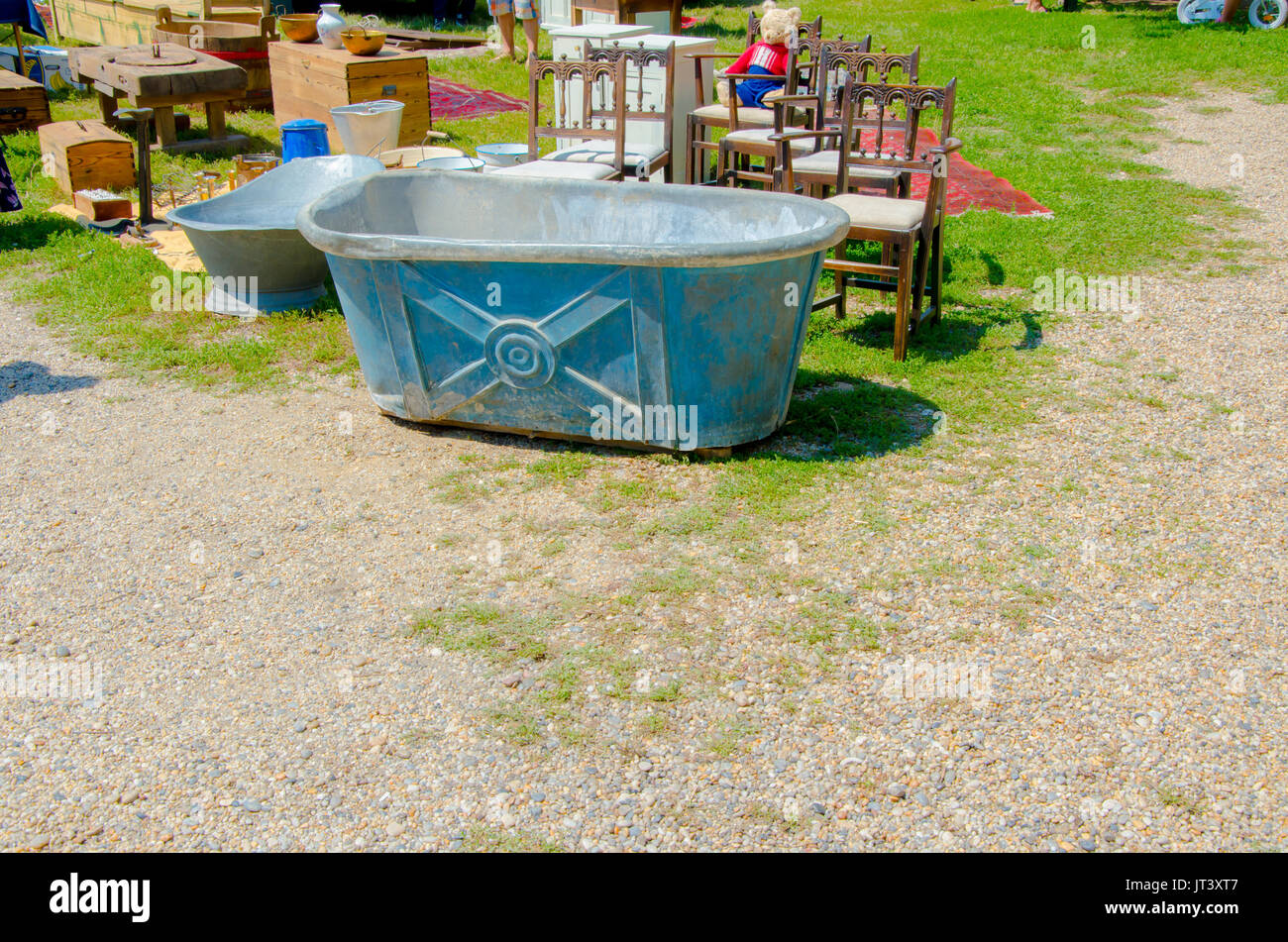 Old bathtub at Flea market, outdoor landscape view with copy space ...