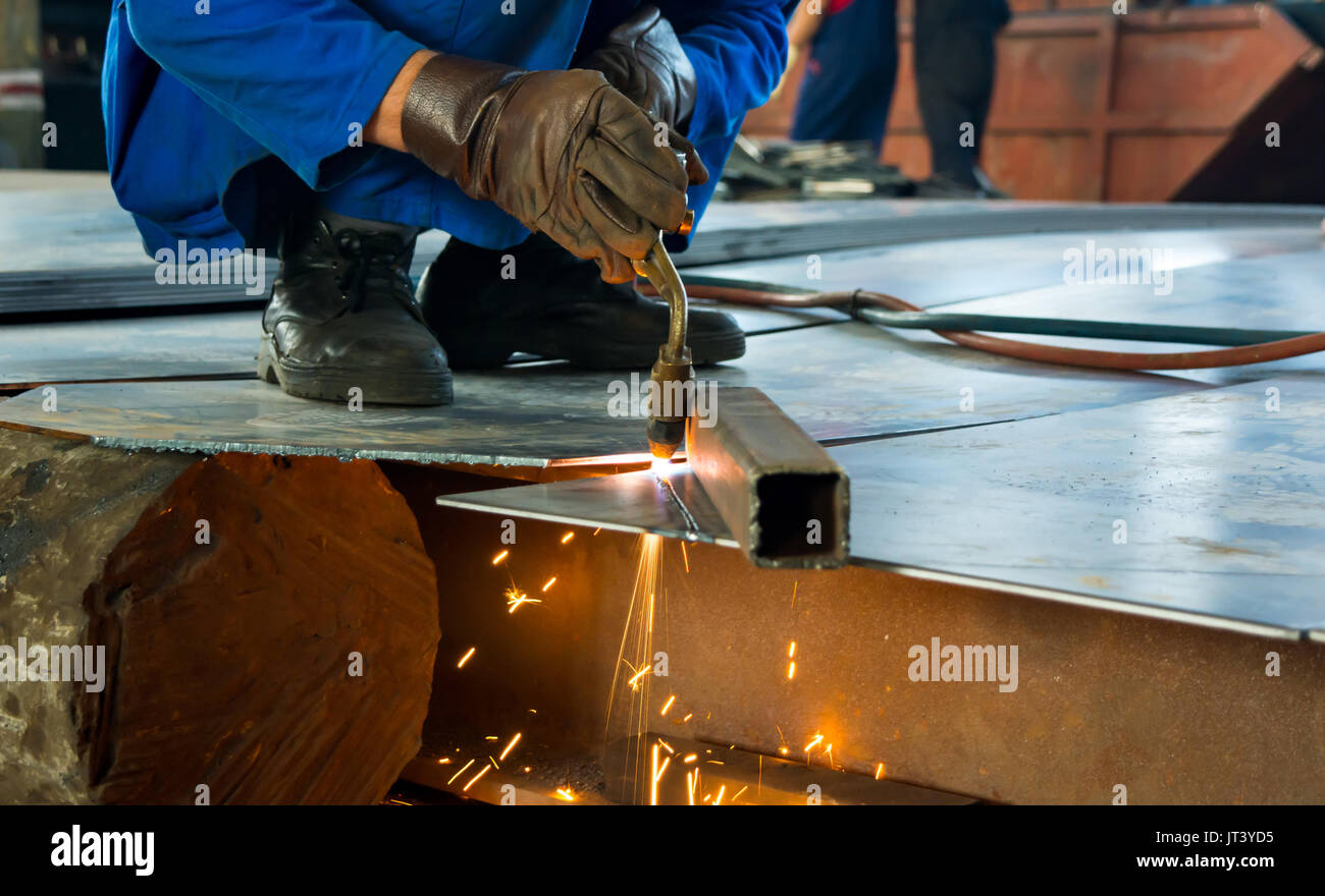 Man cutting metal with fire from a welding cutting torch Stock Photo ...