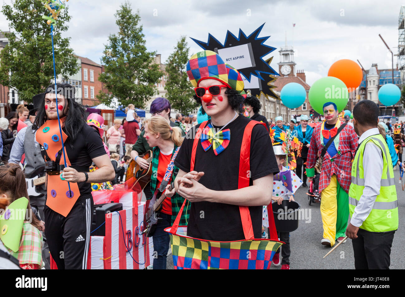People in colourful outfits walk down the High Street at the Stockton ...