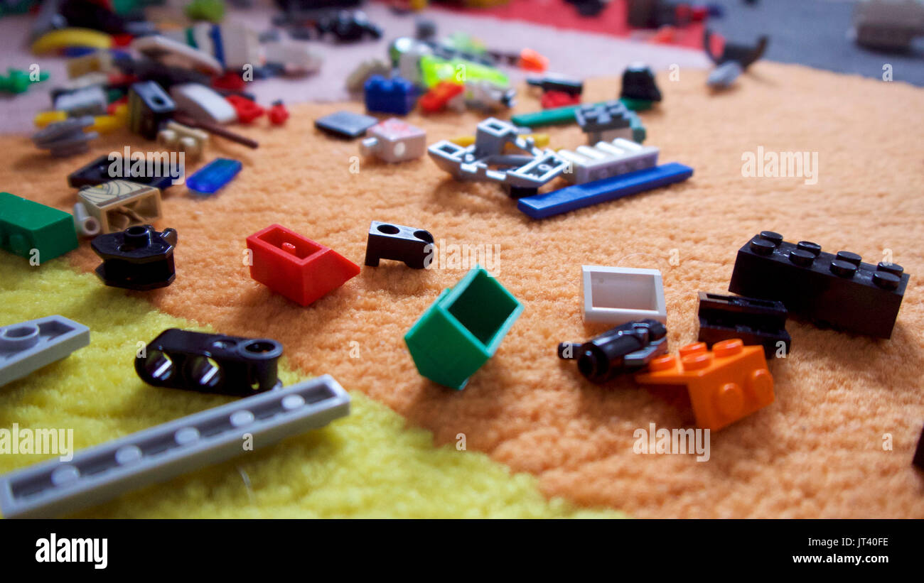 Plastic building bricks on a rug Stock Photo - Alamy