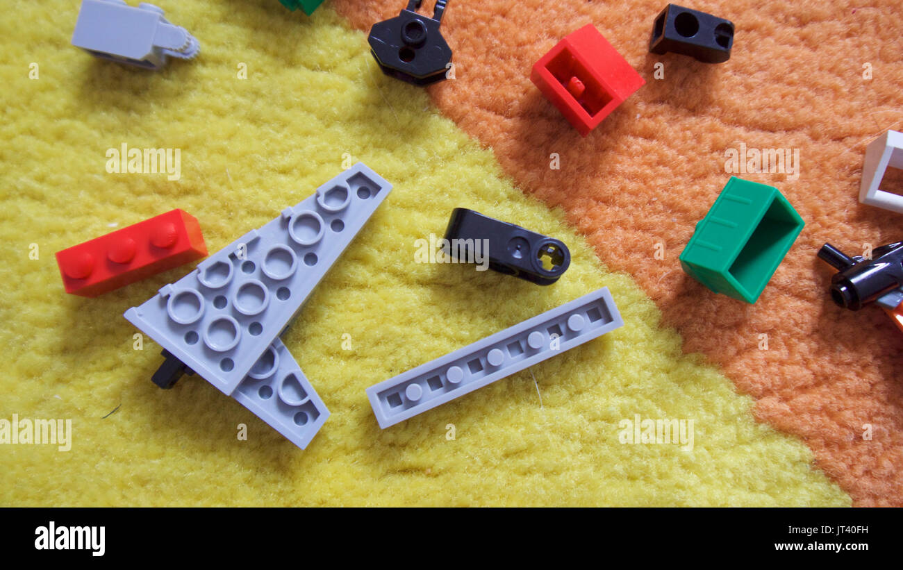 Plastic building bricks on a rug Stock Photo - Alamy