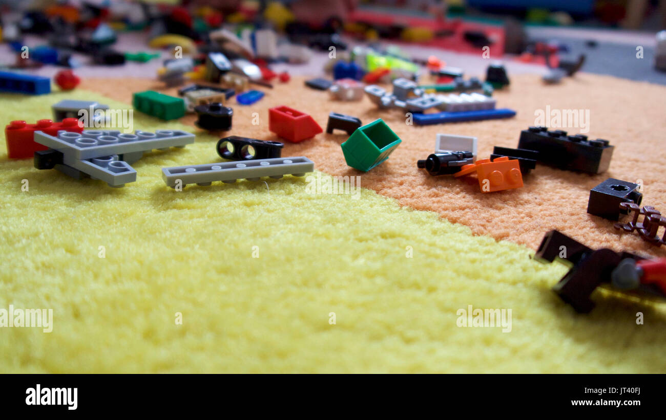 Plastic building bricks on a rug Stock Photo - Alamy
