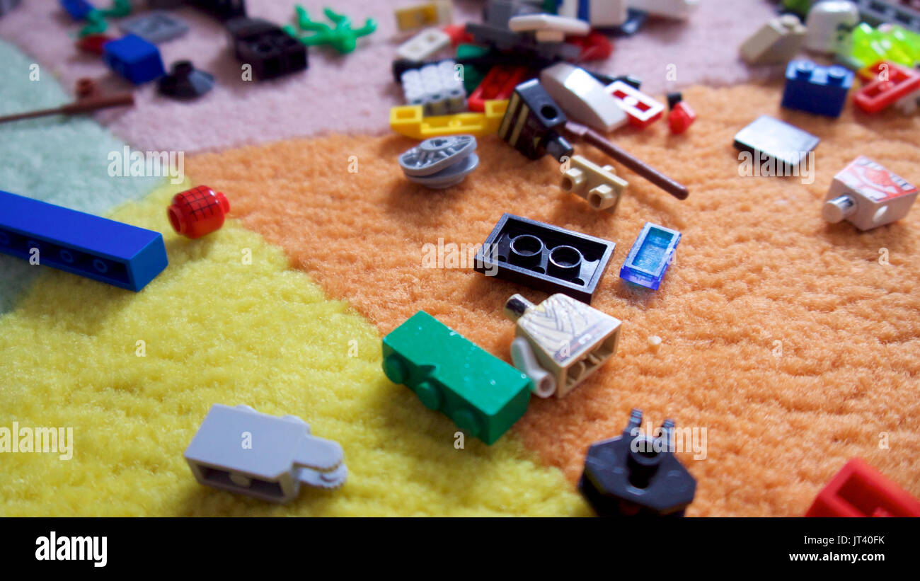 Plastic building bricks on a rug Stock Photo - Alamy