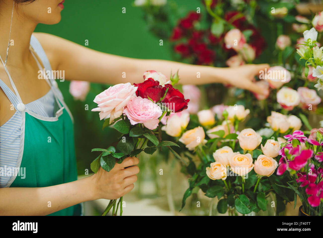 Female florist making beautiful bouquet at flower shop Stock Photo - Alamy