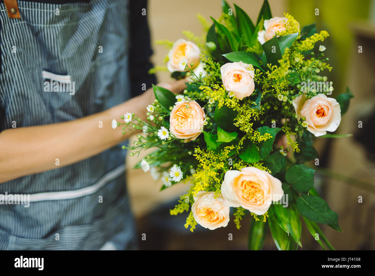Male florist making beautiful bouquet at flower shop Stock Photo - Alamy