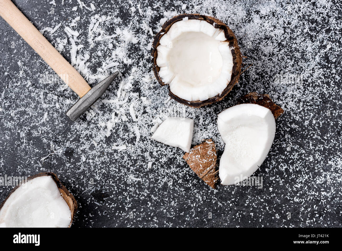 Top view of fresh broken coconut with shavings on black Stock Photo - Alamy