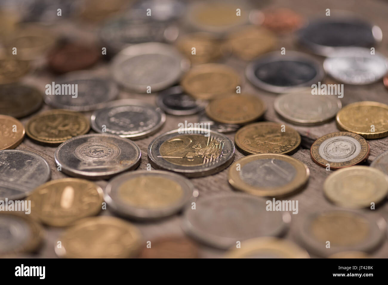 collection of different coins on wooden tabletop, pile of coins concept ...