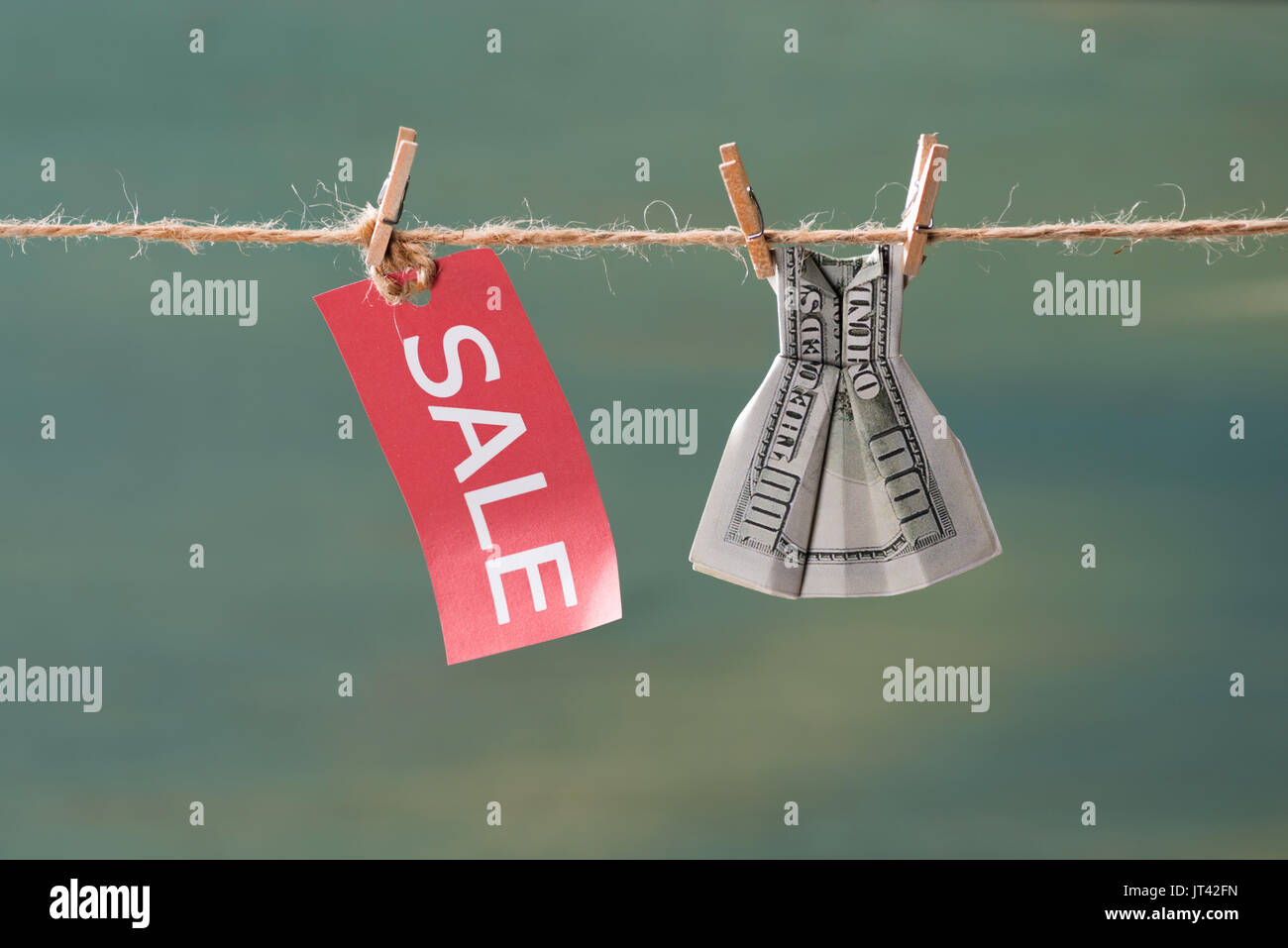 sale sign and one hundred us dollar banknote on clothesline, offer sale ...