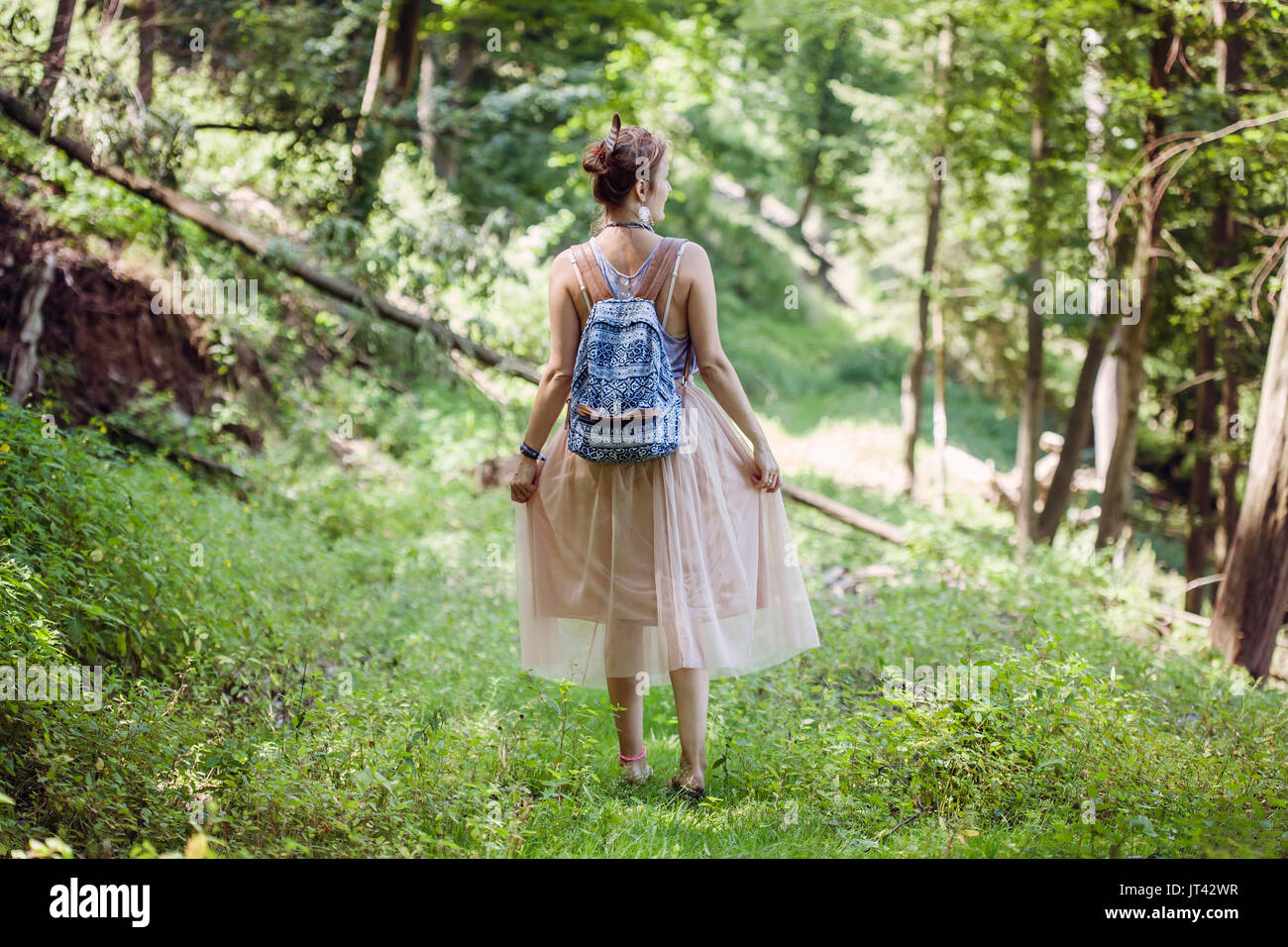 Girl walking away in the forest, enjoying nature Stock Photo - Alamy