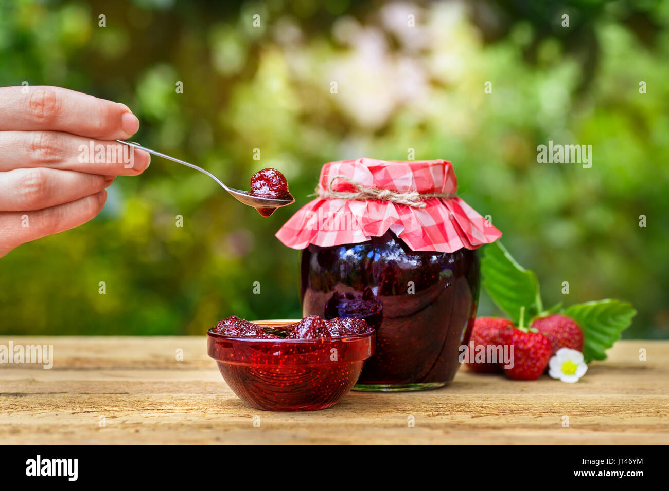 still life with strawberry jam on table with sunshine blurred natural ...