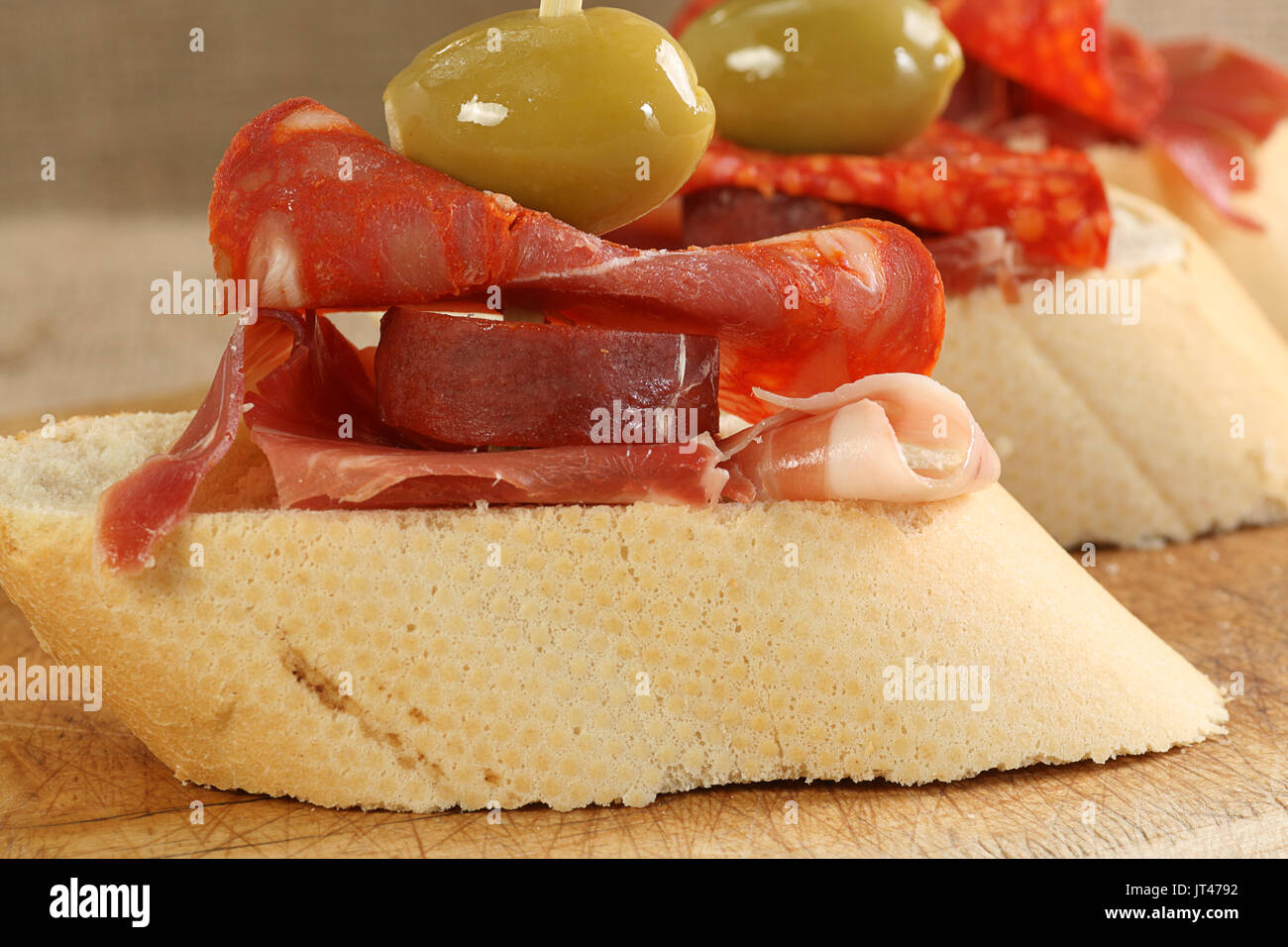 selection of spanish meat with olives on sliced crusty bread Stock ...