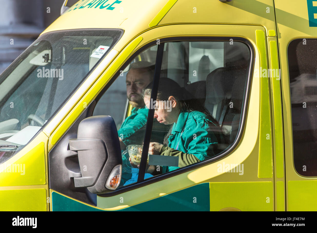 Ambulance stationary in traffic in London, UK. The female paramedic is ...