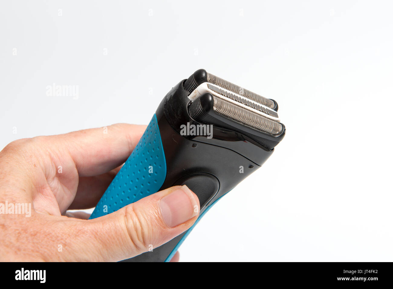 Hand holding an electric razor Stock Photo - Alamy