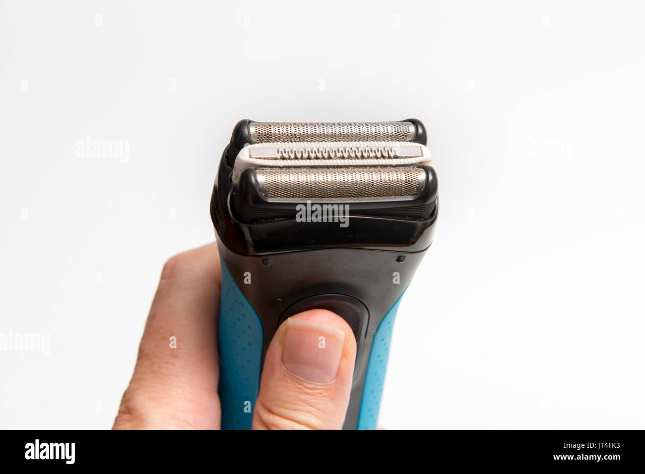 Hand holding a modern electric razor Stock Photo - Alamy