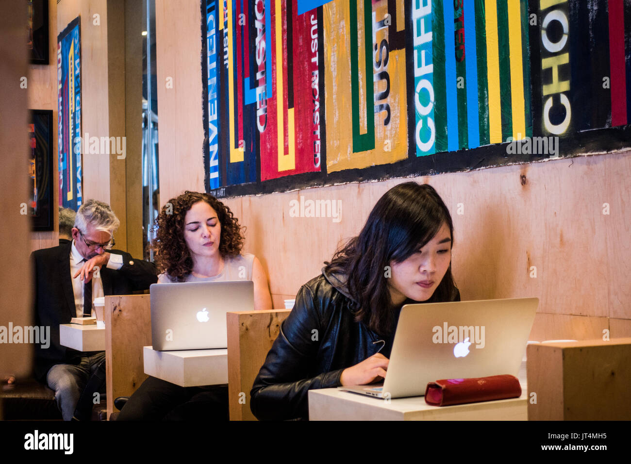 NEW YORK, USA - October 13, 2016. People working on computers in a Cafe ...