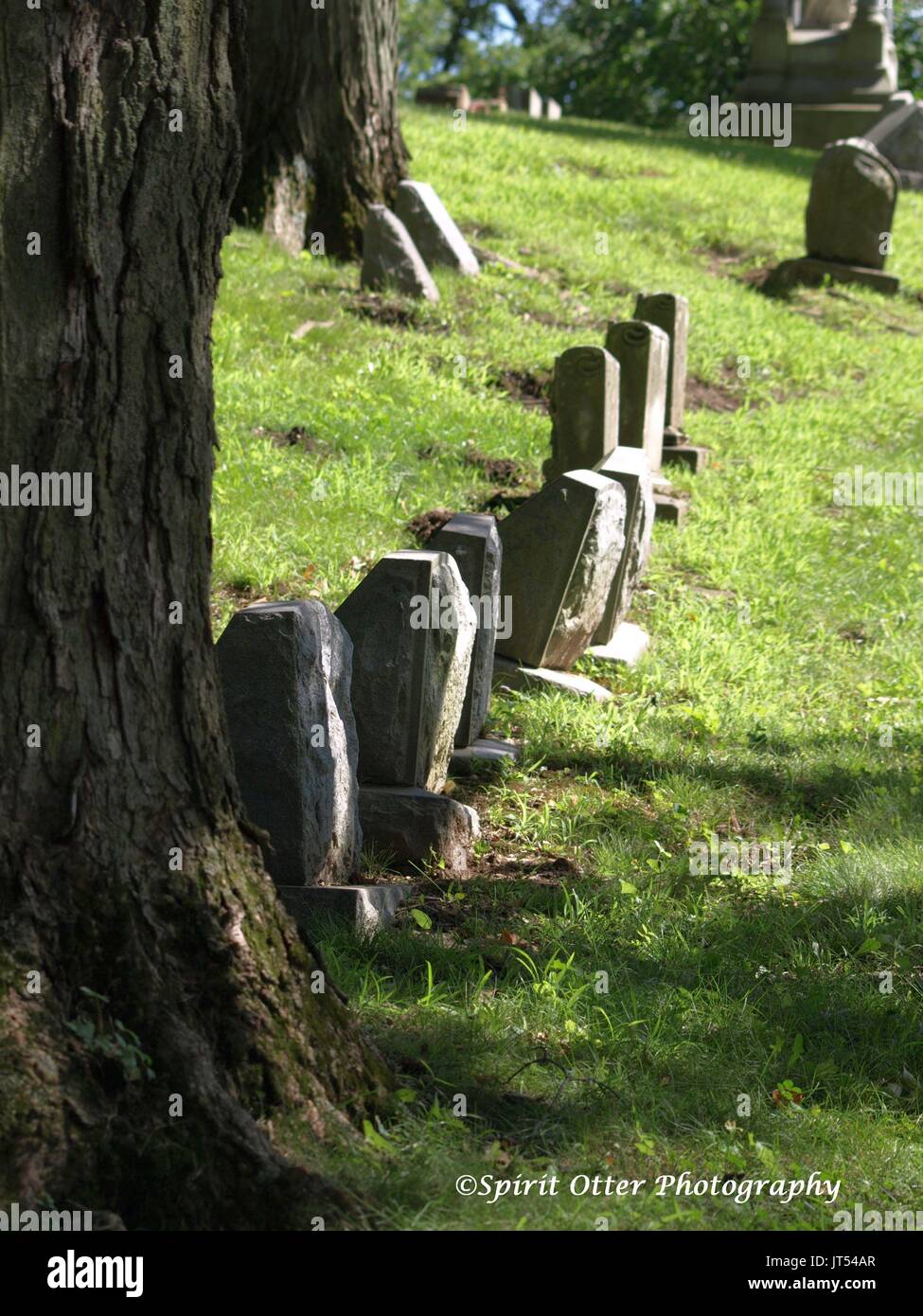 An older peaceful resting place of the dead, no names shown Stock Photo - Alamy