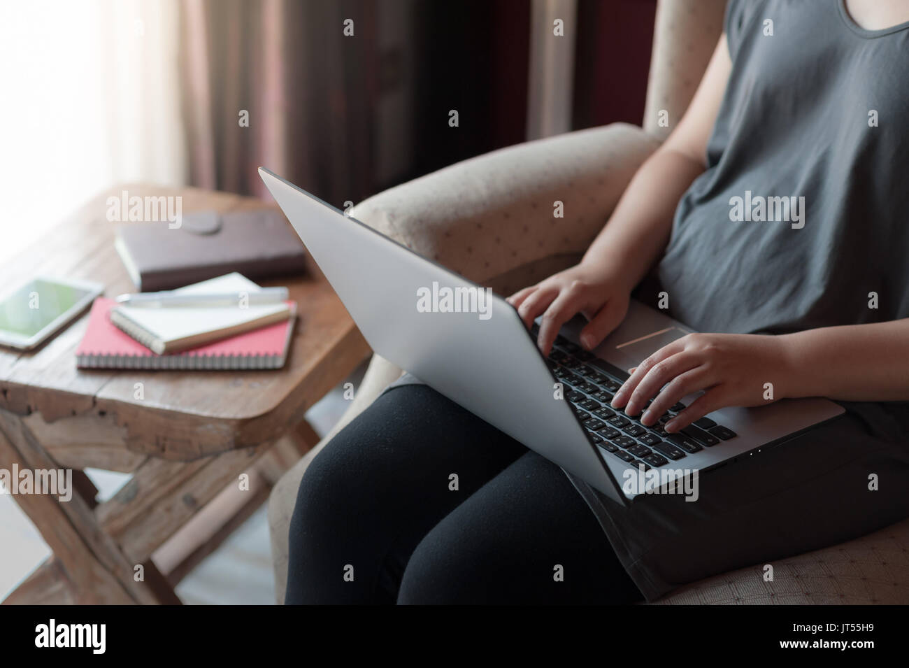 Woman typing on laptop computer keyboard while using internet for ...