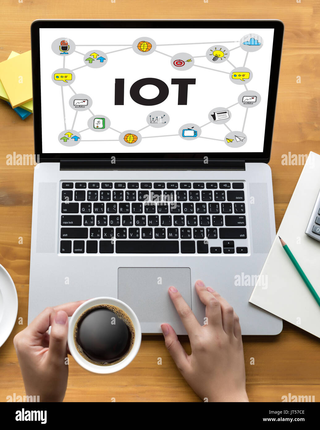 IOT business man hand working and internet of things (IoT) word diagram ...