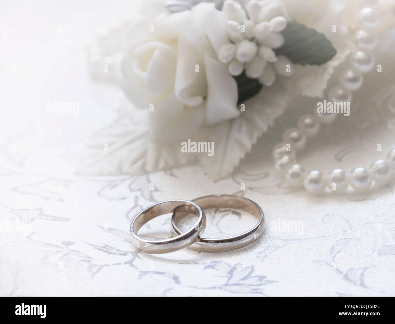 golden wedding rings in decorative arrangement Stock Photo - Alamy