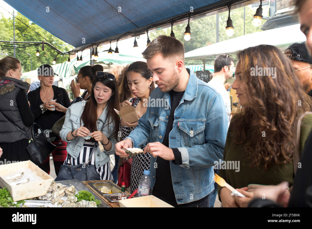 Hackney . Broadway market. Sunday morning. Selling oysters outide the ...