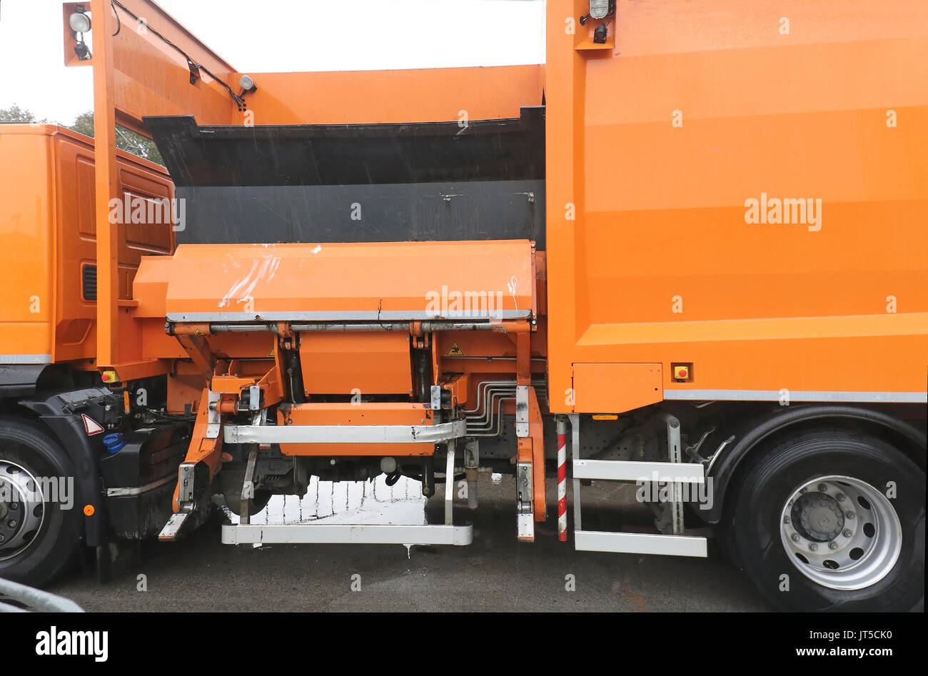 Municipal truck vehicle collecting garbage containers on the streets ...