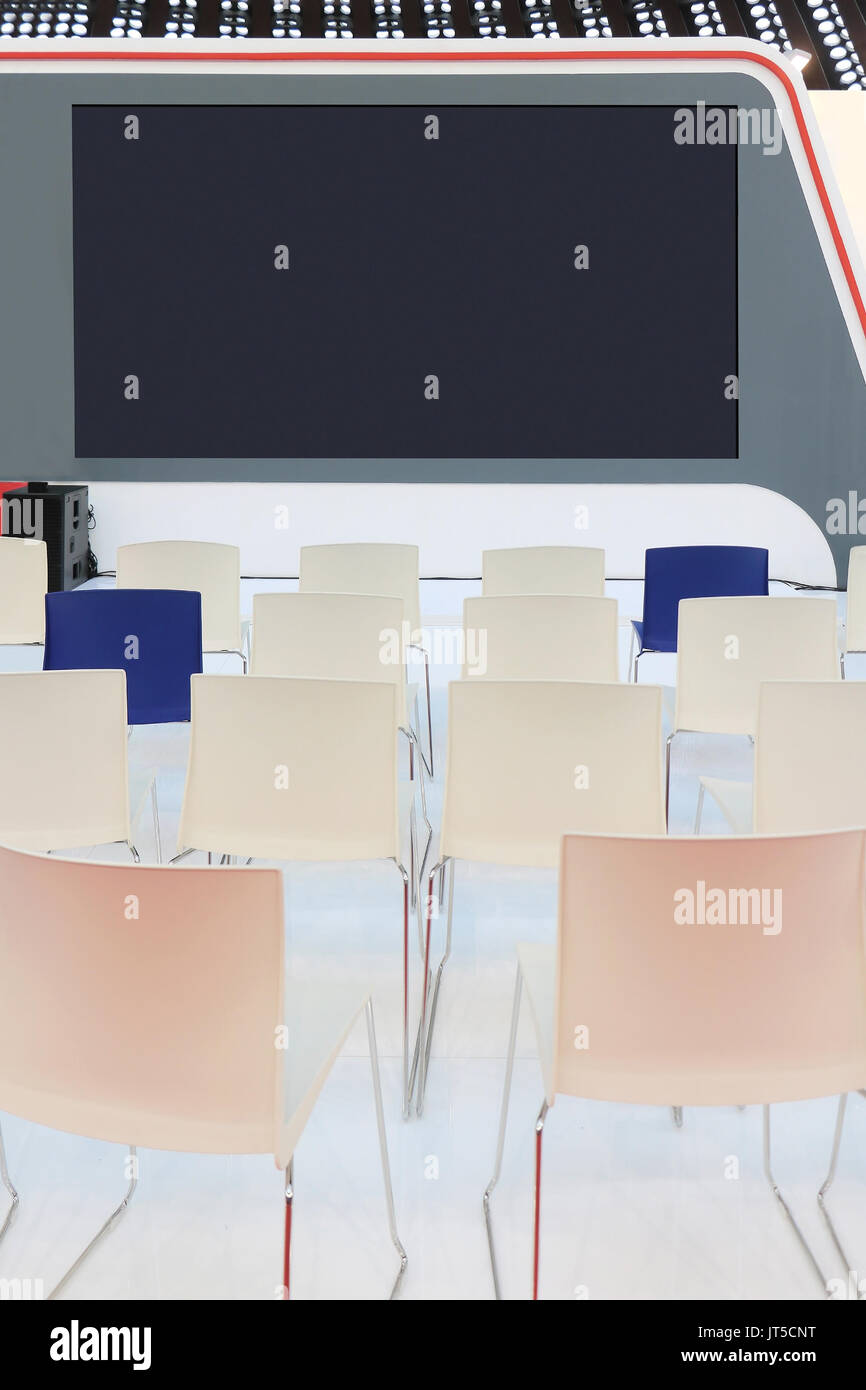 Presentation room with empty chairs and blank display Stock Photo - Alamy