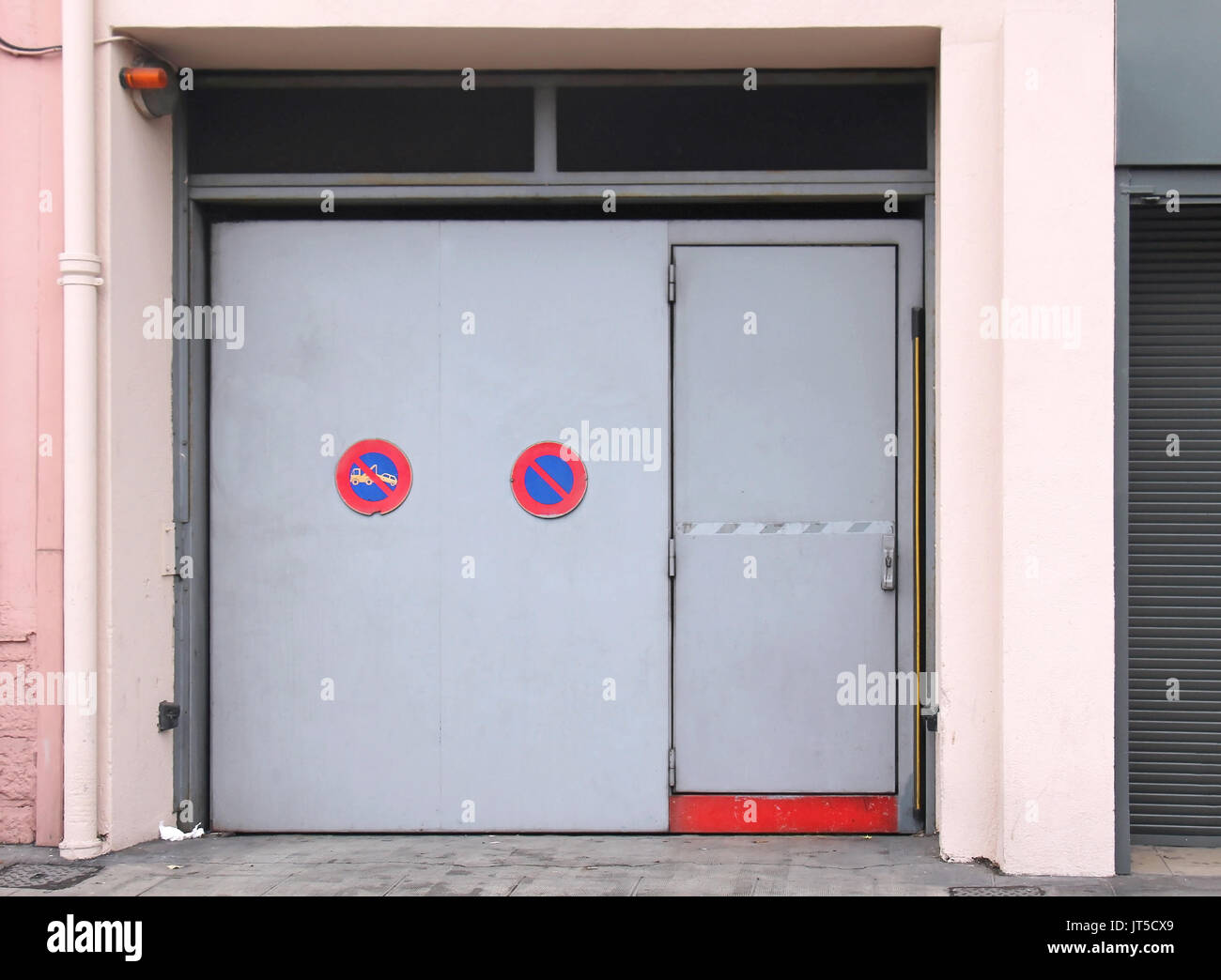 Closed exterior garage door with no parking sign and warning Stock ...
