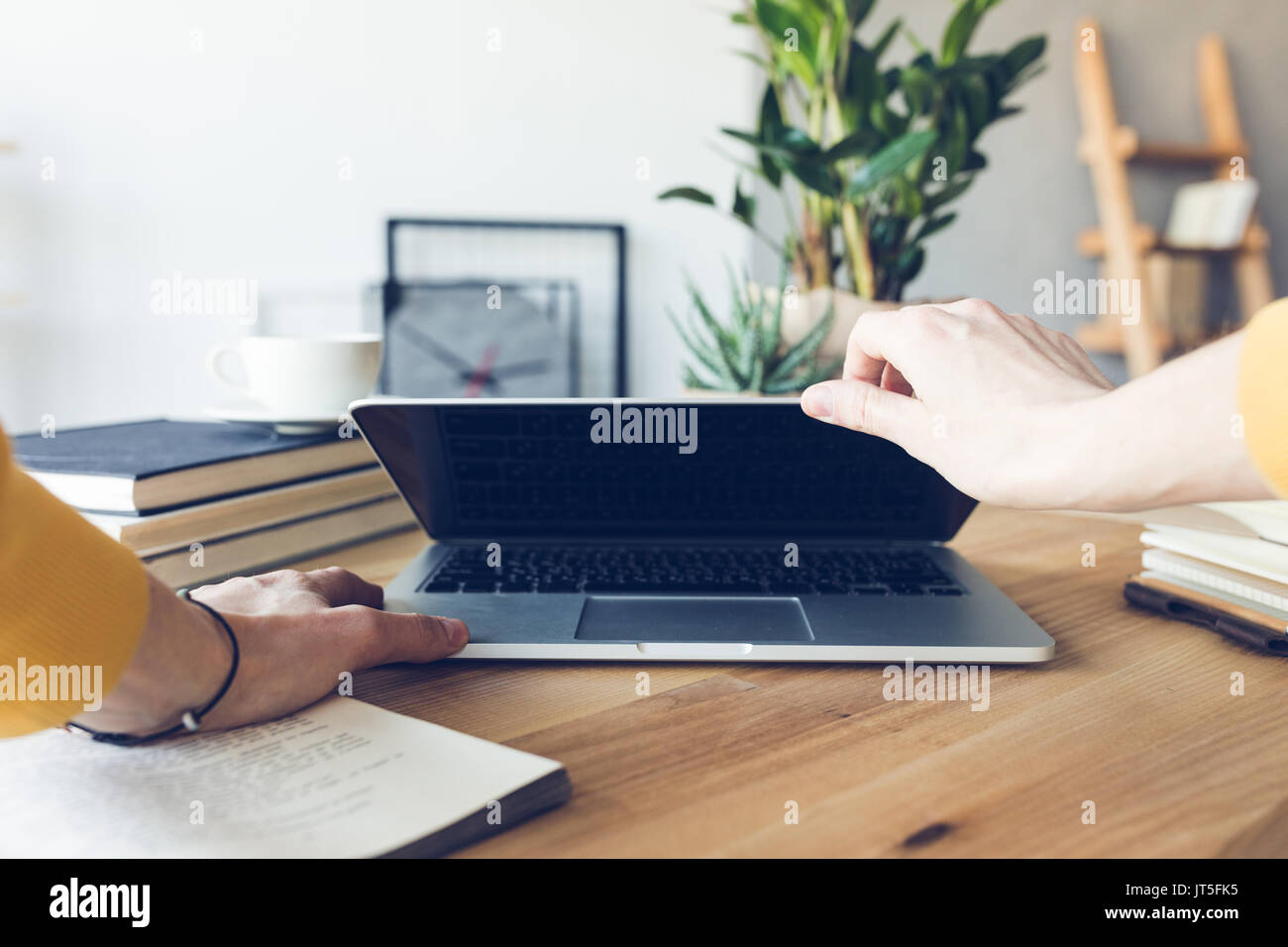human hands holding laptop at workplace in home office Stock Photo - Alamy