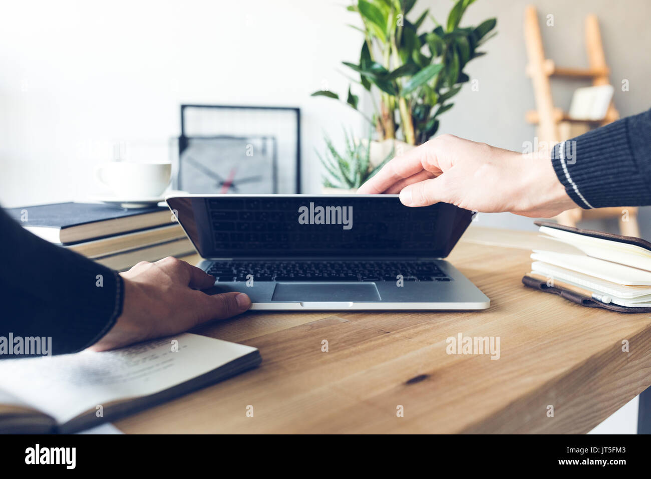 human hands holding laptop at workplace in home office Stock Photo - Alamy