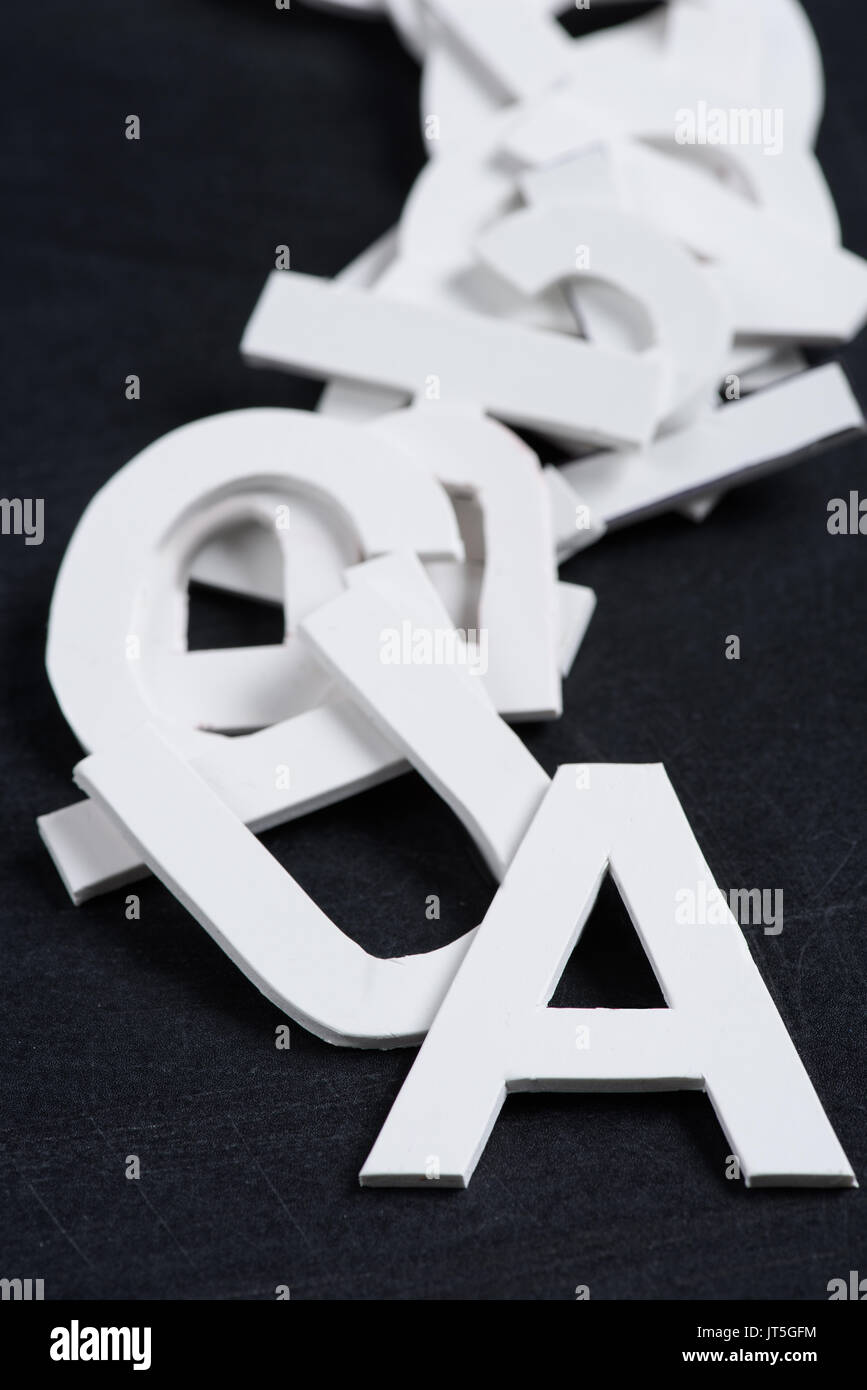 heap of white paper letters on black school chalkboard Stock Photo - Alamy
