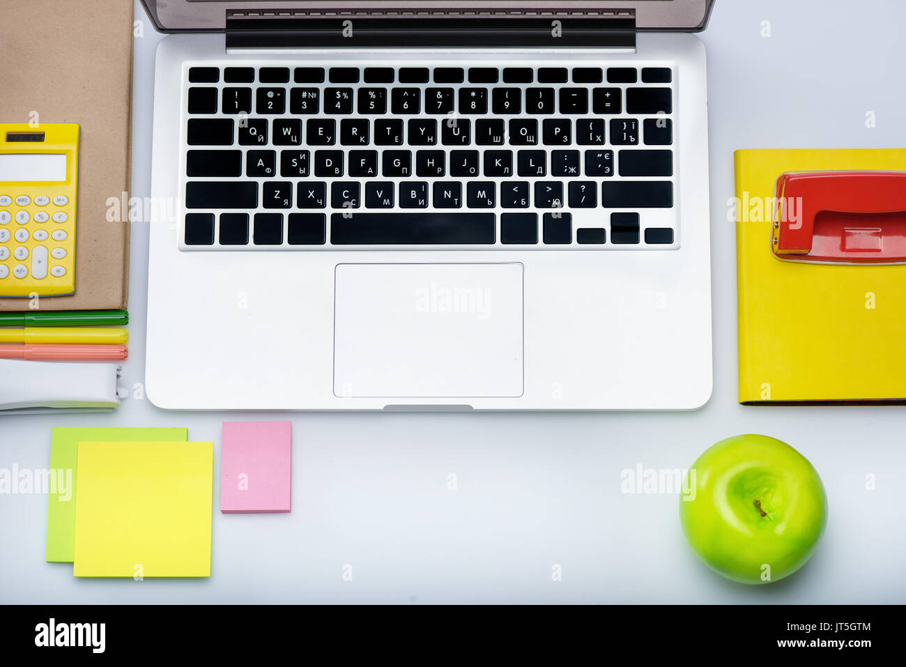 flat lay with Laptop computer and colorful office supplies isolated on ...