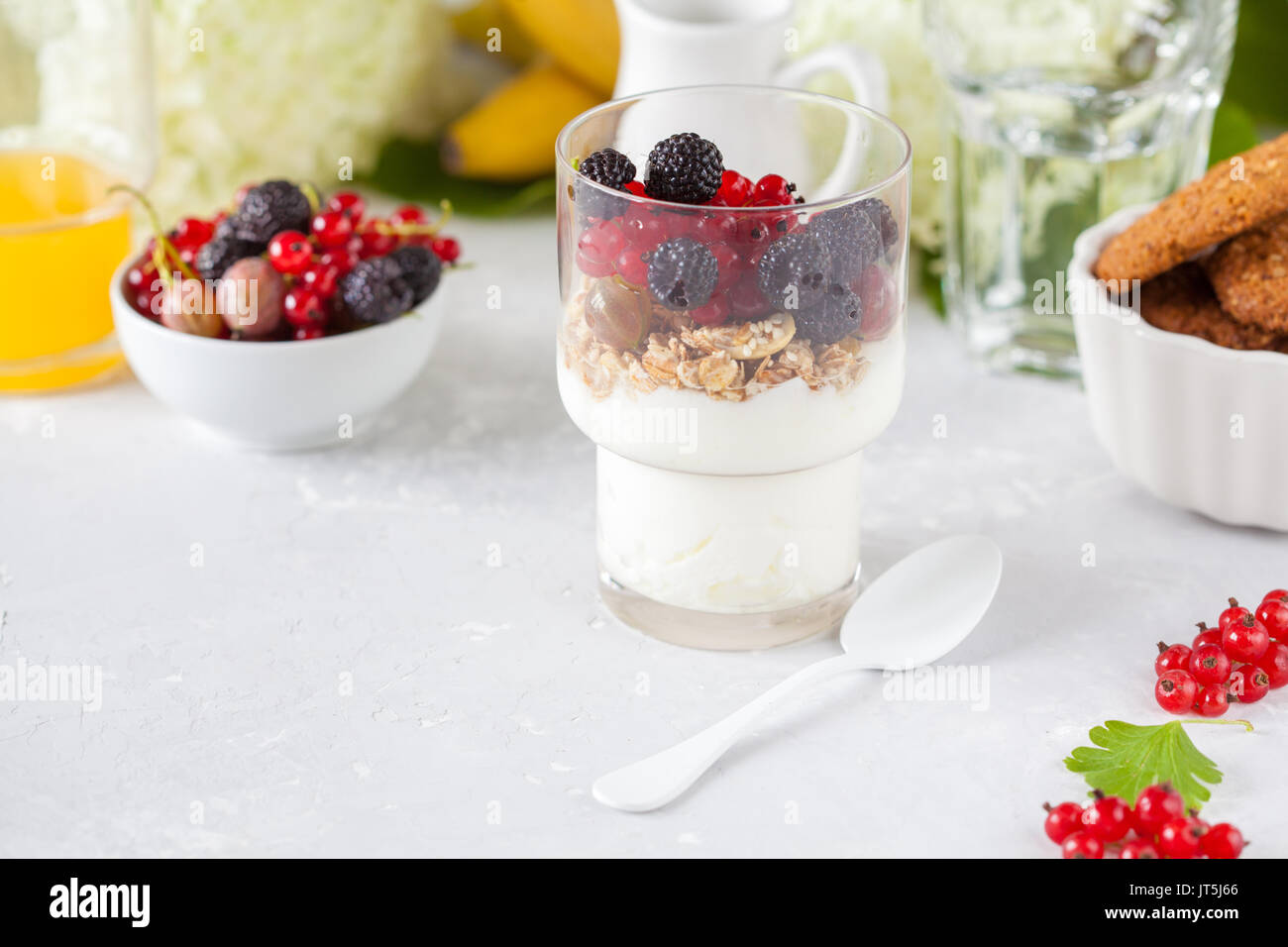 Healthy light breakfast: parfait with berries and yogurt, orange juice ...