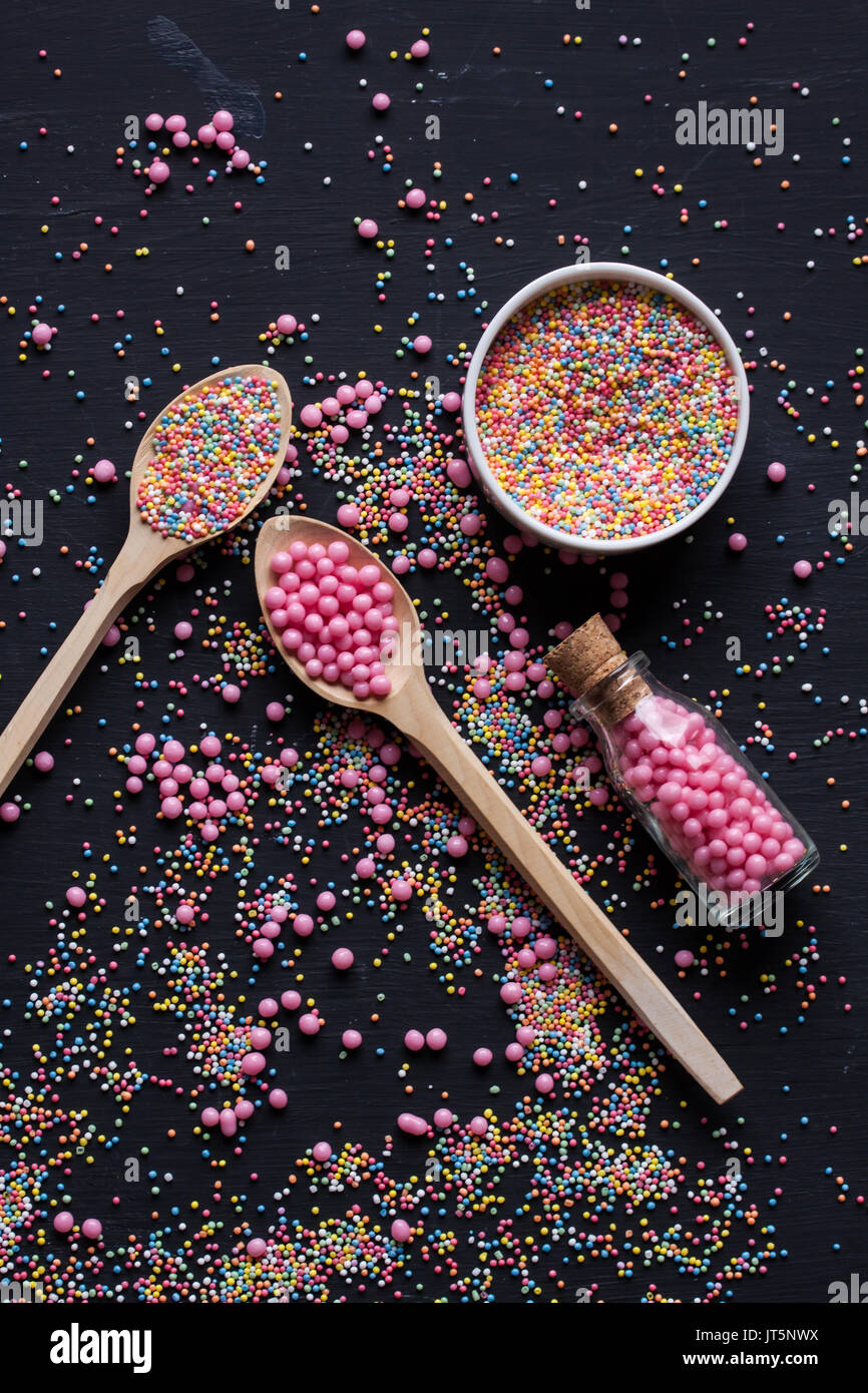 sugar sprinkles on a black background Stock Photo - Alamy