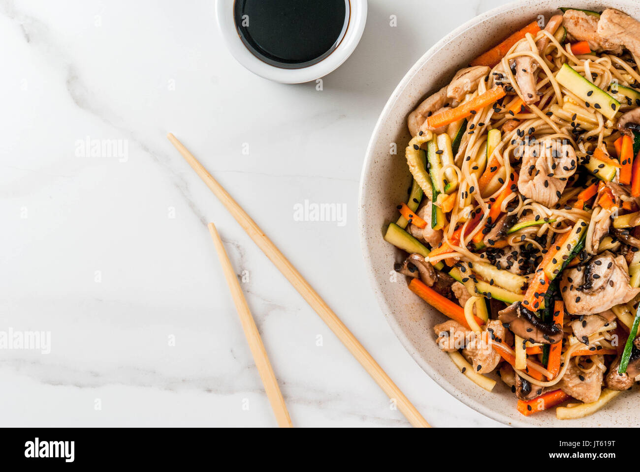 Traditional Asian food. Lunch stirfry: rice noodles, zucchini, carrots ...