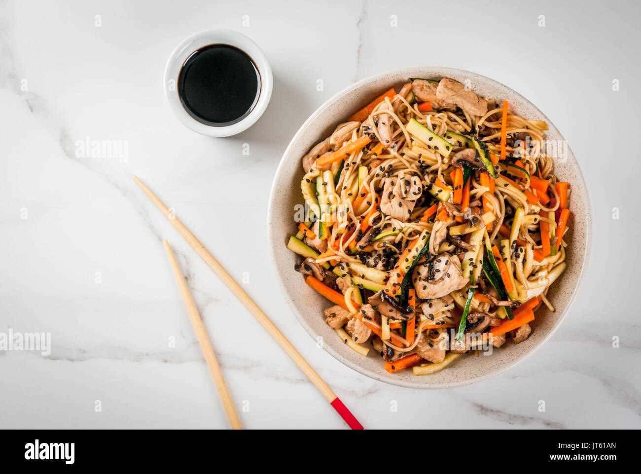 Traditional Asian food. Lunch stirfry: rice noodles, zucchini, carrots ...