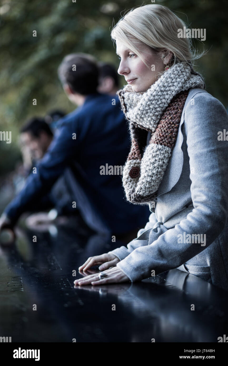 NEW YORK, USA - October 14, 2016. Sad woman looking at the Names of ...