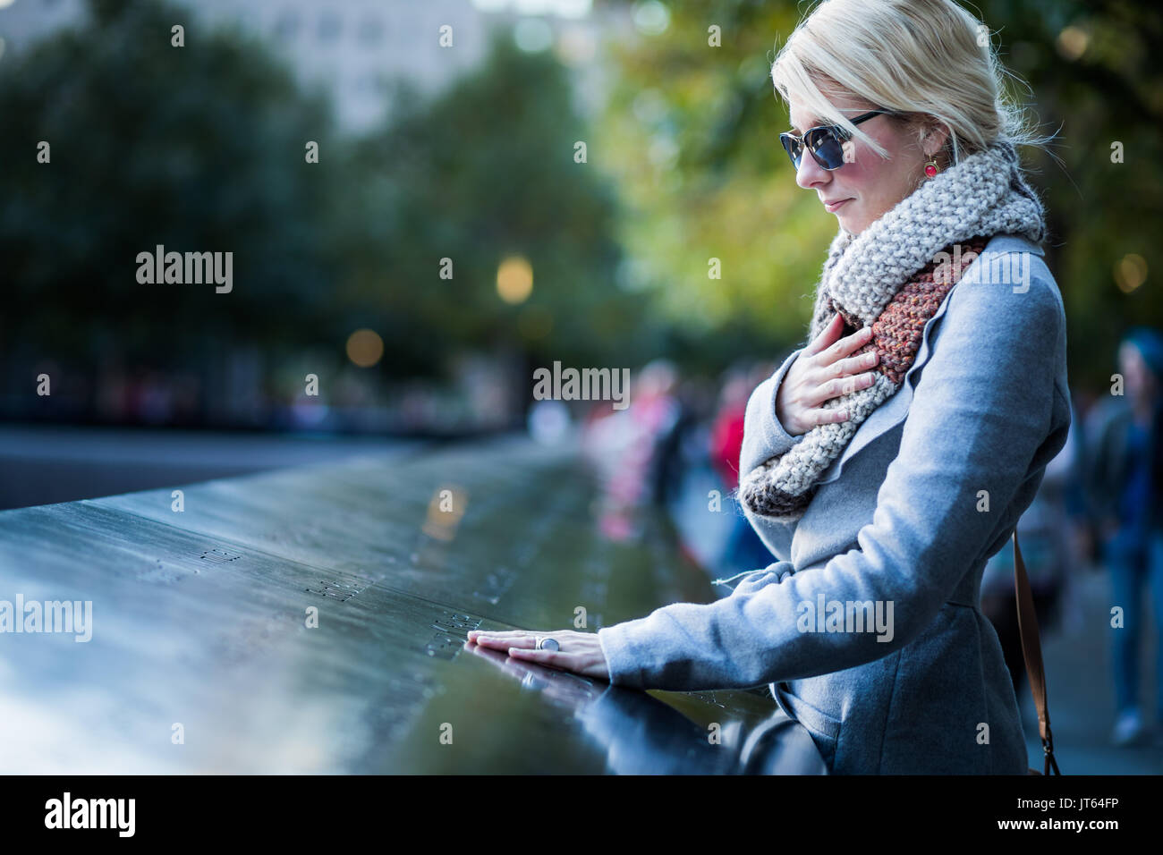 NEW YORK, USA - October 14, 2016. Sad woman looking at the Names of ...