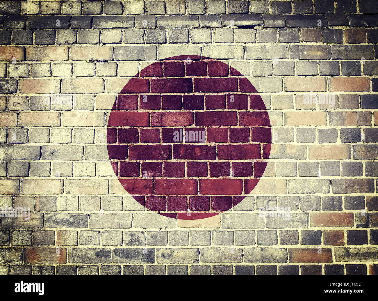 Faded Japanese flag on an old brick wall background with a dark ...