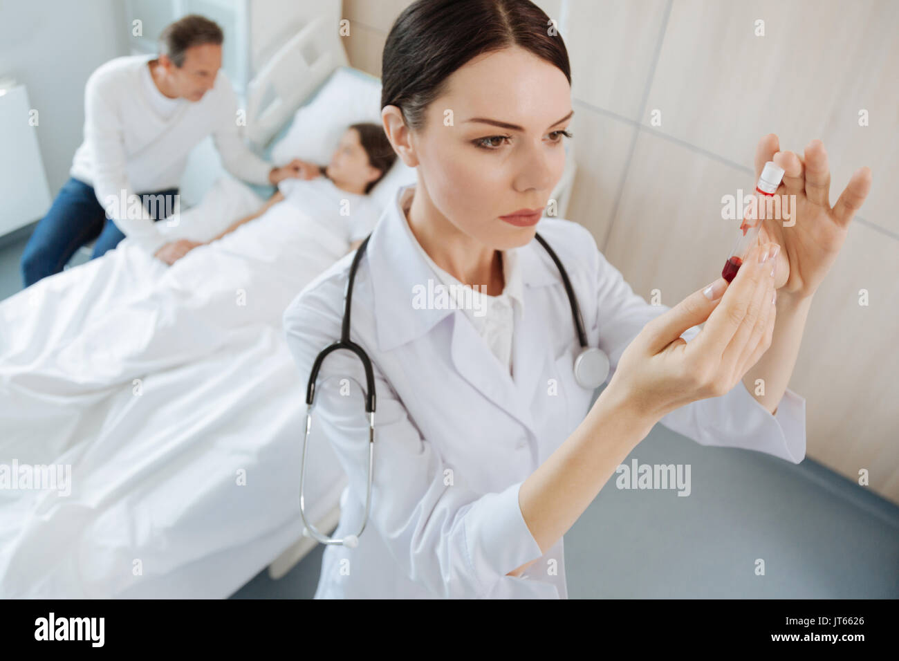 Doctor looking test tube blood hi-res stock photography and images - Alamy